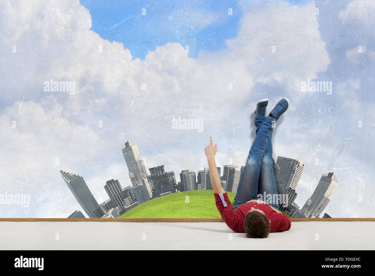 Young man lying on floor with legs raised up Stock Photo - Alamy