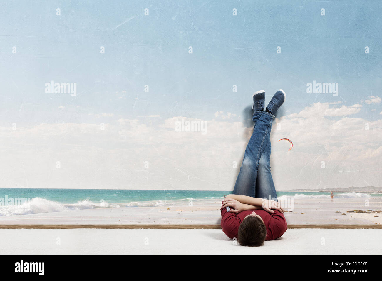 Young man lying on floor with legs raised up Stock Photo - Alamy