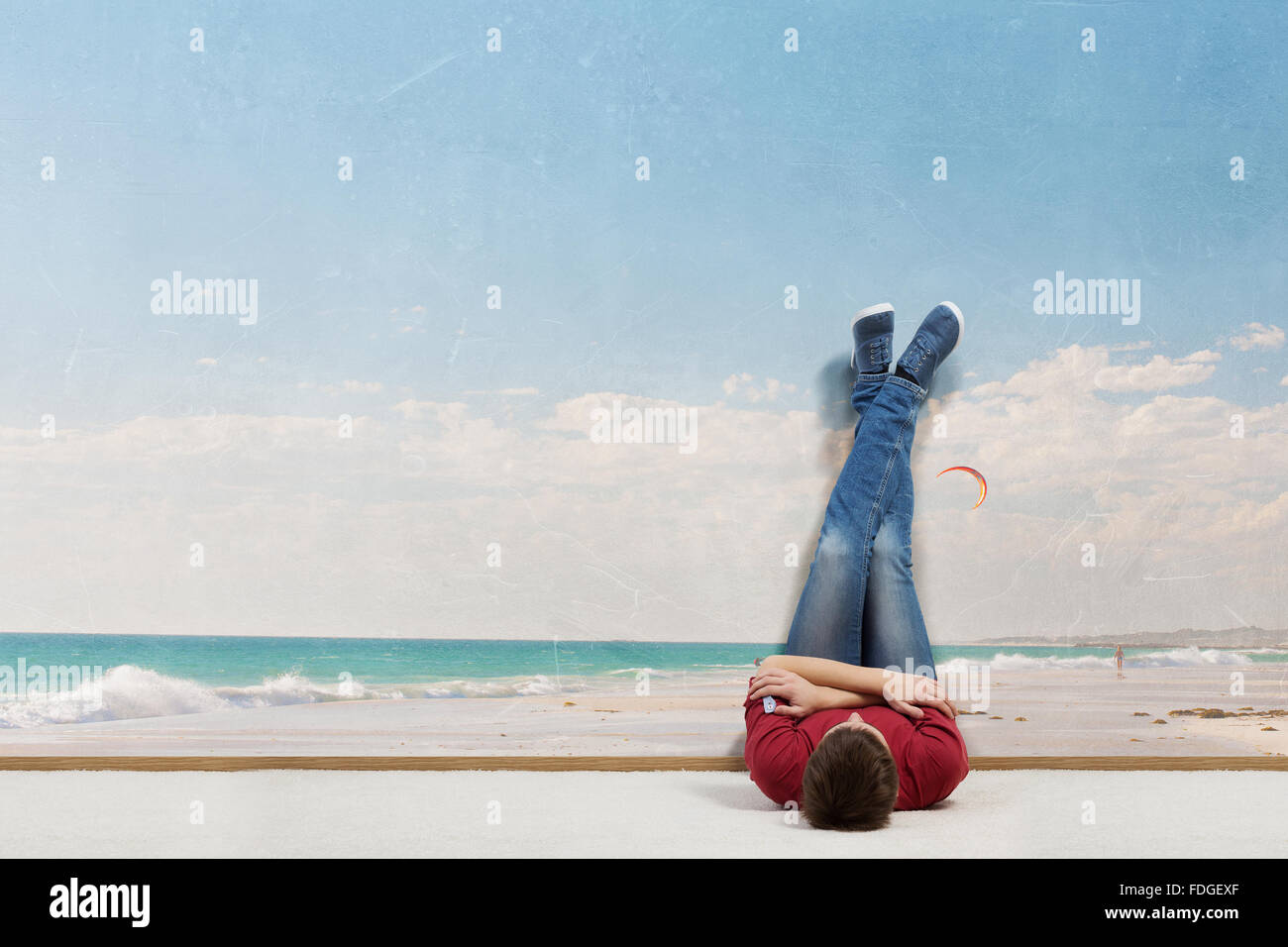 Young man lying on floor with legs raised up Stock Photo - Alamy