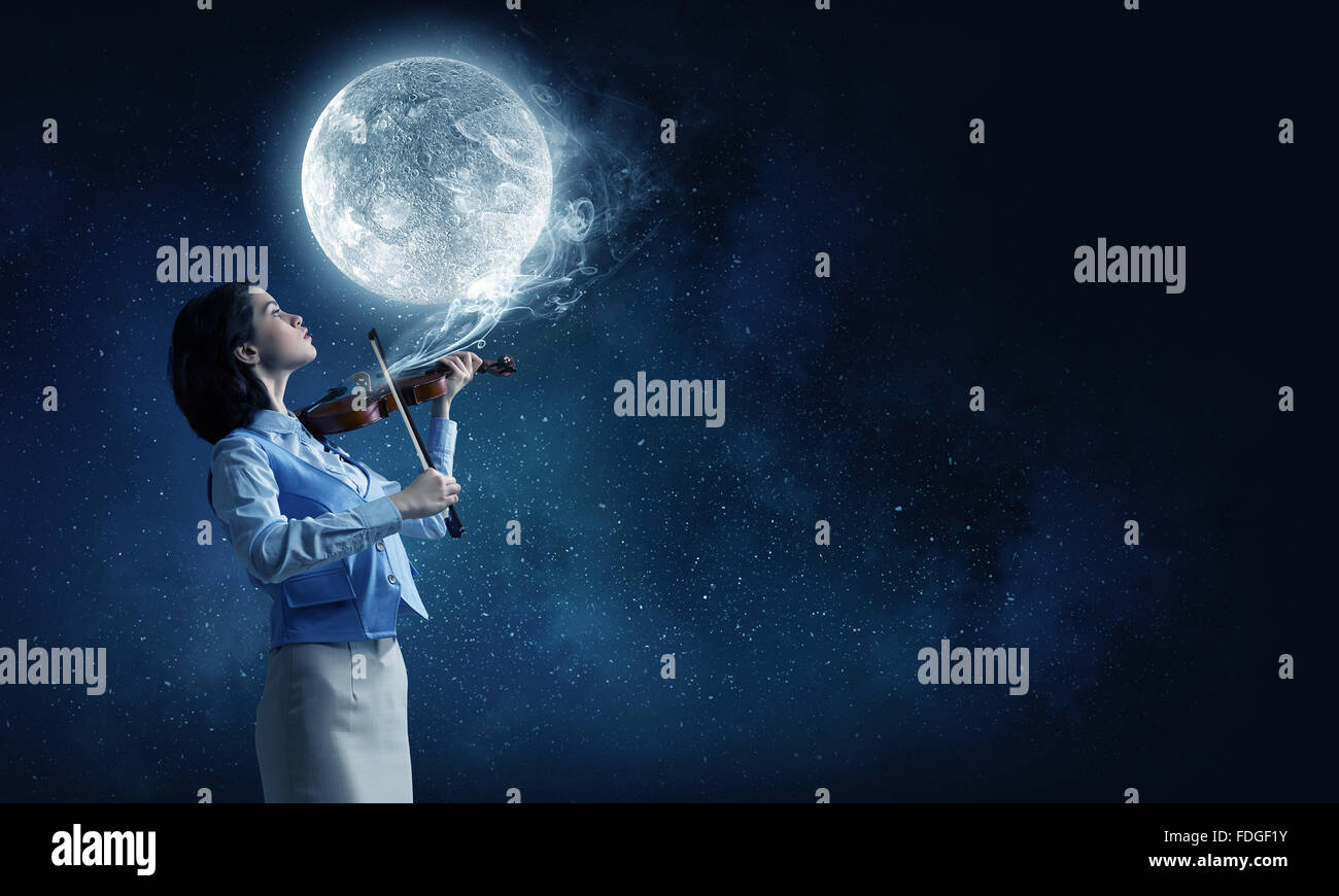 Young woman playing violin and full moon in sky Stock Photo - Alamy