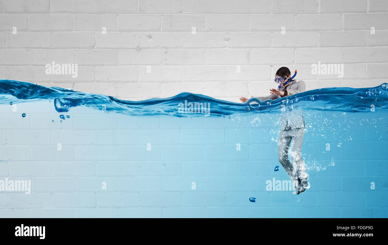 Young businessman in suit and diving mask jumping in water Stock Photo ...