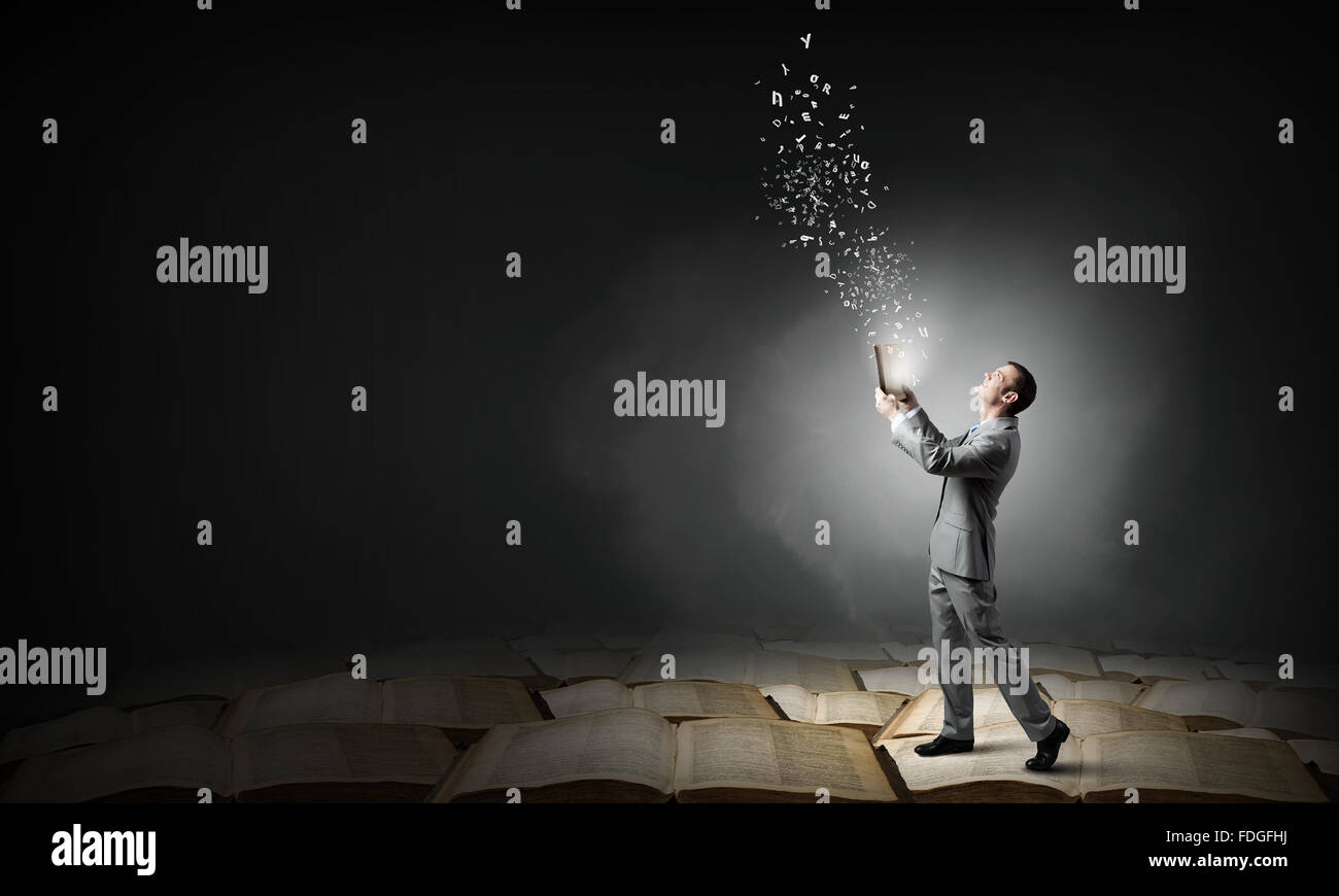 Young handsome businessman with old book in hands Stock Photo - Alamy