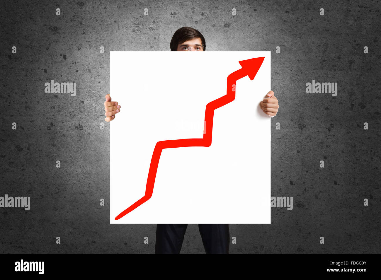 Businessman holding poster with red rising arrow Stock Photo - Alamy