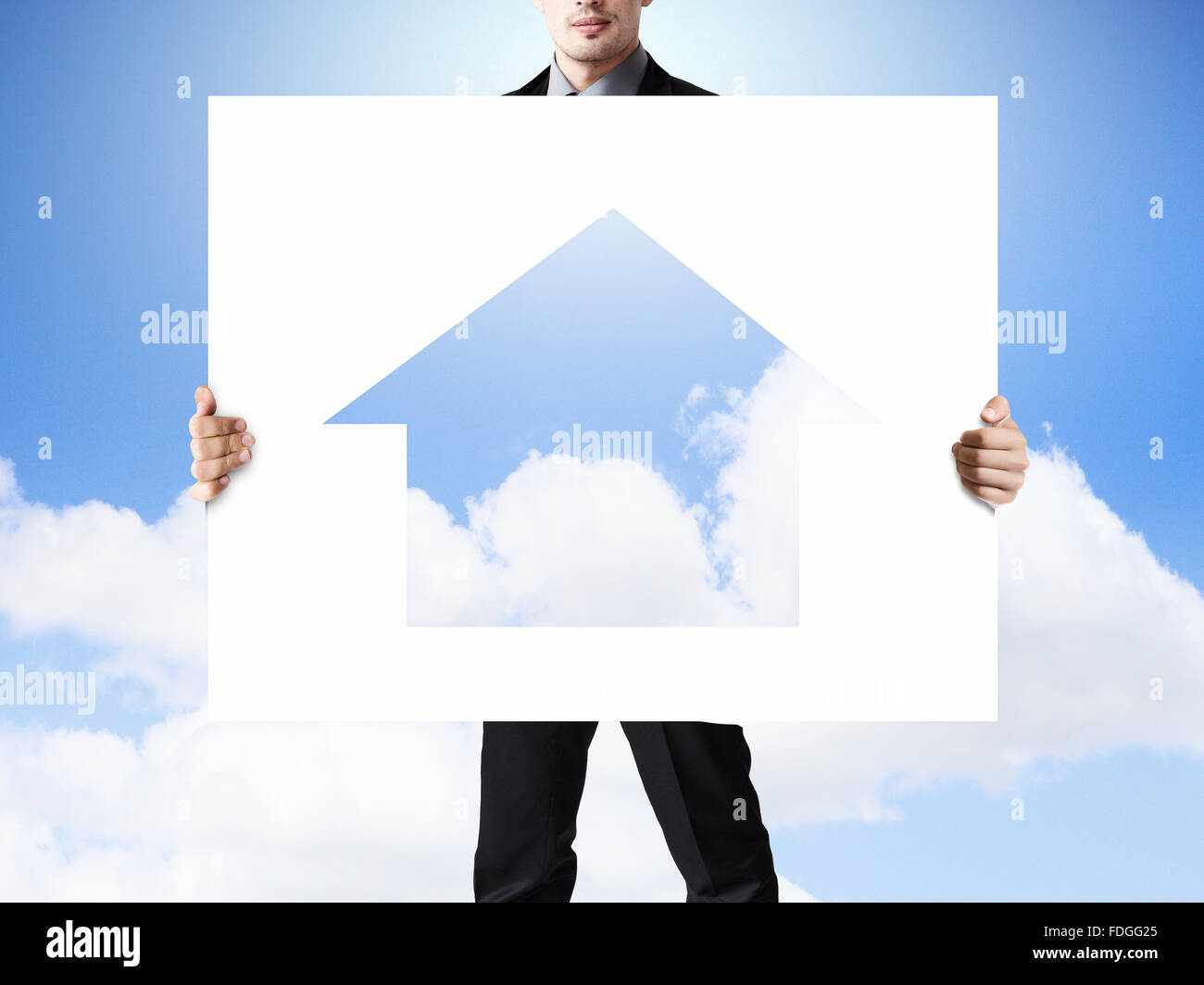 Businessman in suit holding placard with house symbol Stock Photo - Alamy