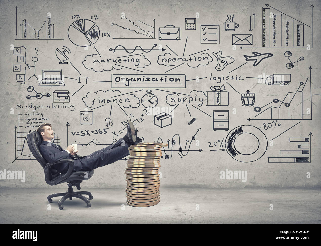 Young confident businessman sitting in chair with legs on stack of ...