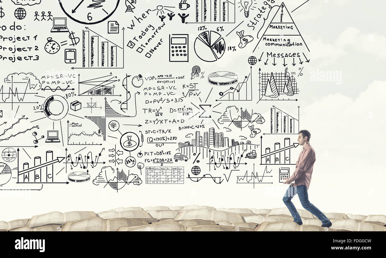 Young man carrying banner with his great business plan Stock Photo - Alamy
