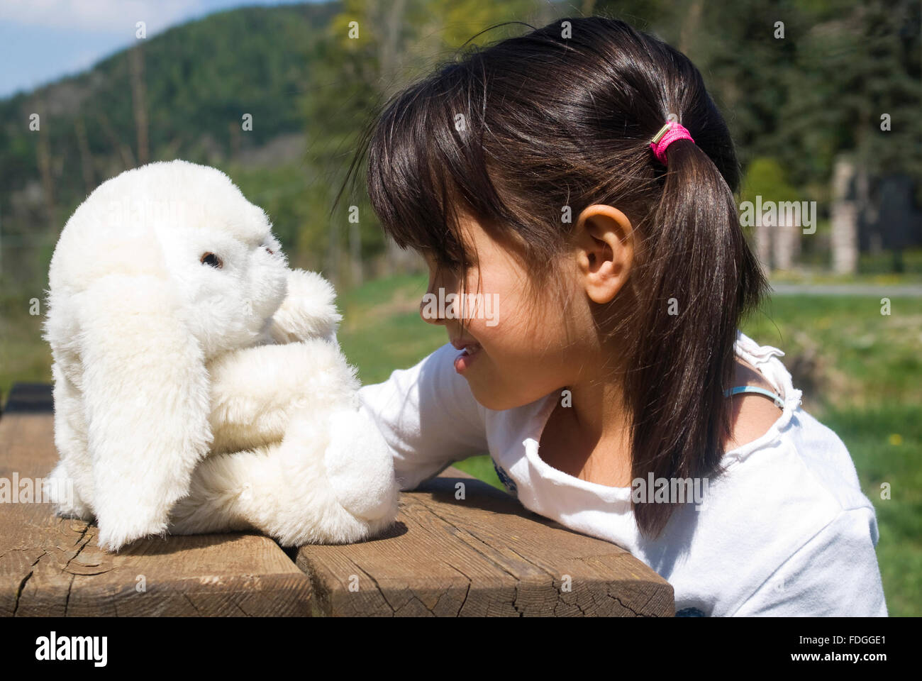 Girl hugging soft toy Stock Photo - Alamy