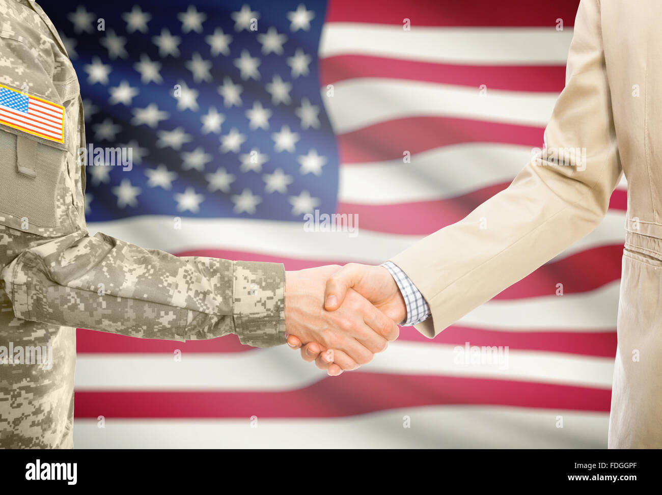 American soldier in uniform and civil man in suit shaking hands with ...