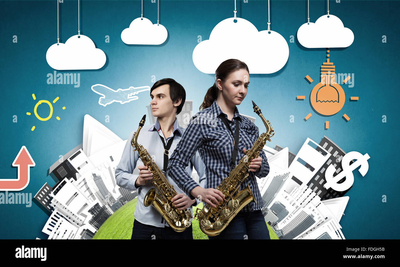Duet of young man and woman musicians playing saxophones Stock Photo ...