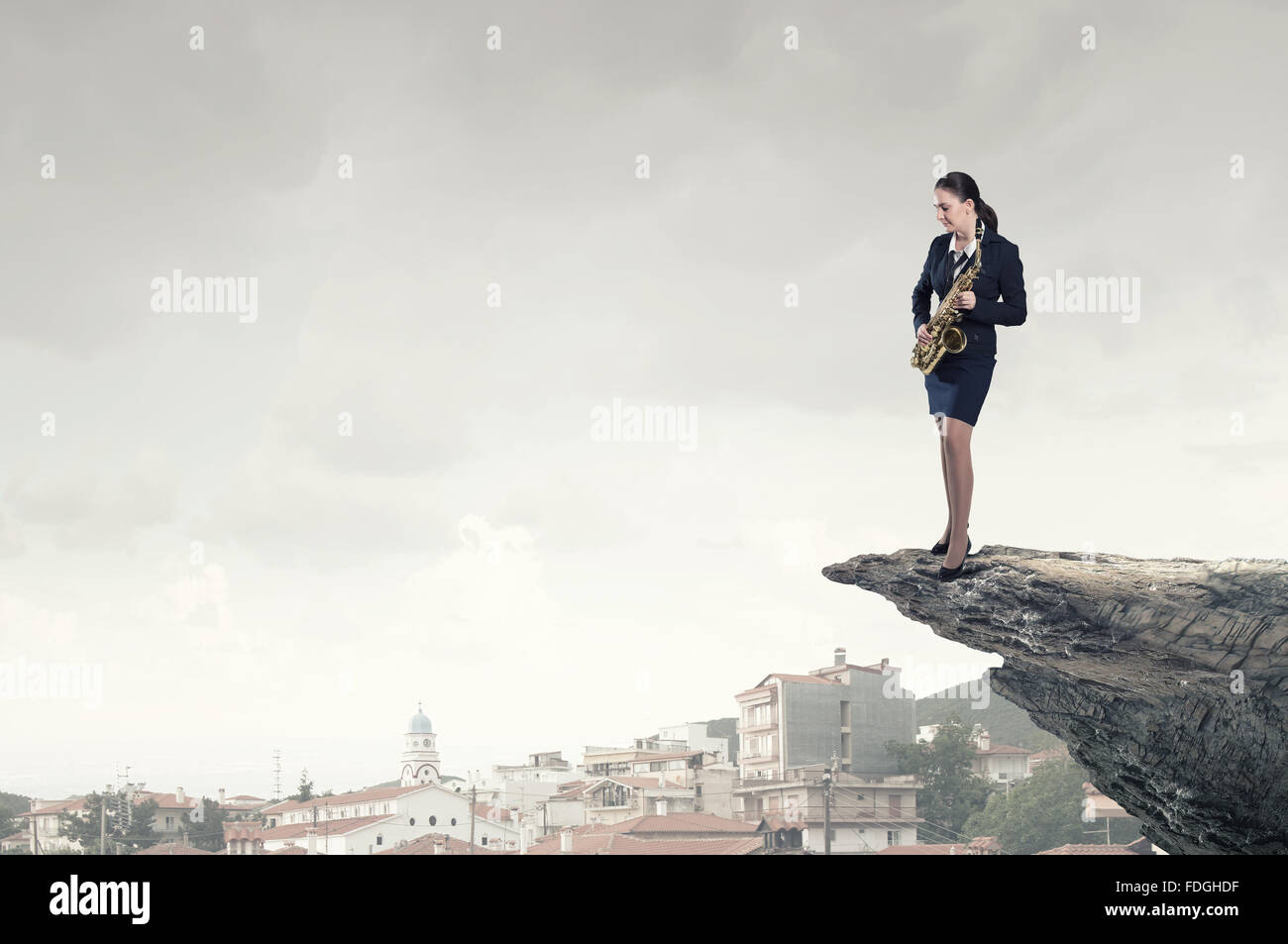 Young woman in suit with saxophone in hands Stock Photo - Alamy