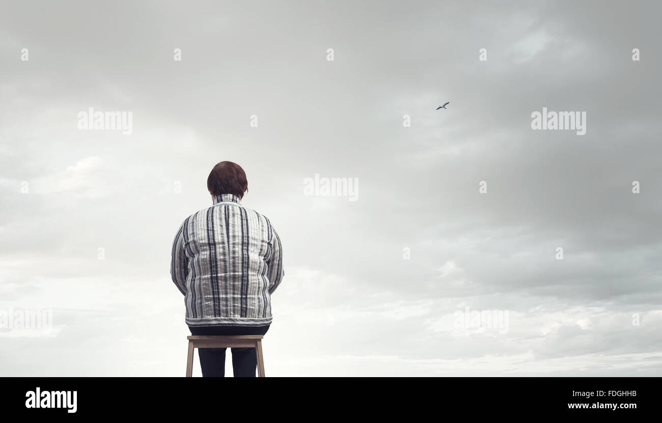 Back view of plus size woman sitting on chair Stock Photo - Alamy