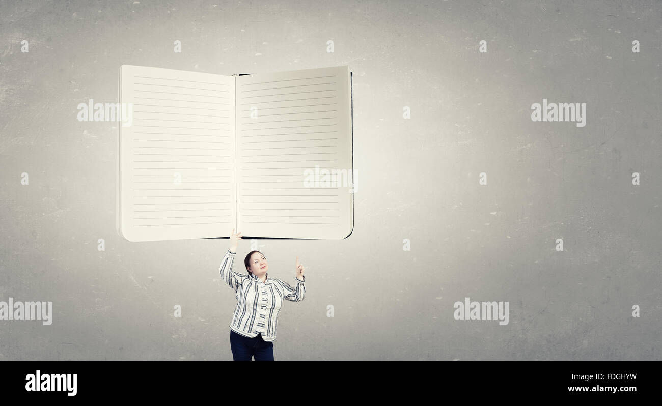 Middle aged stout woman in blue dress holding huge notepad Stock Photo ...