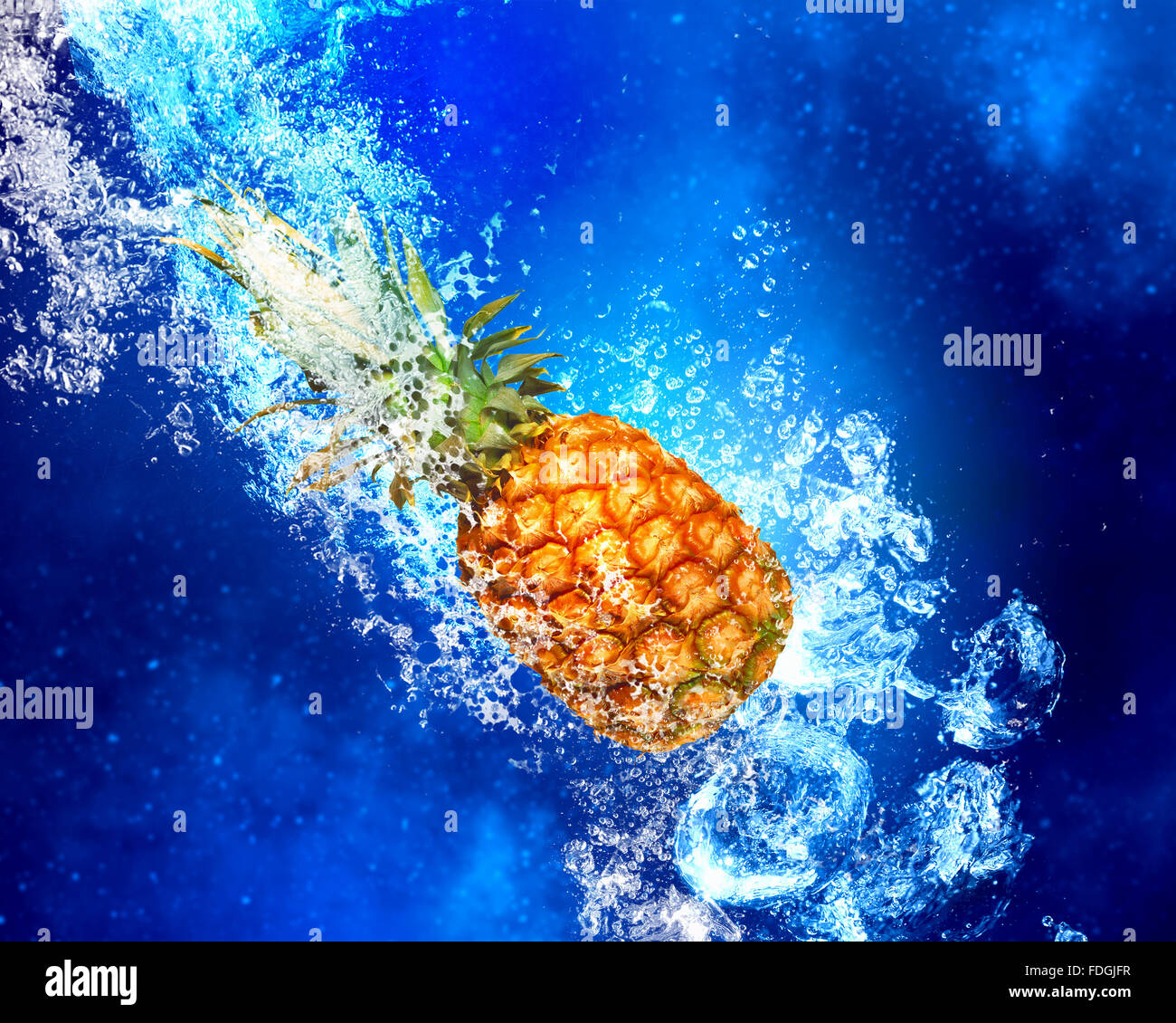 Fresh pineapple in clear blue water splashes Stock Photo - Alamy