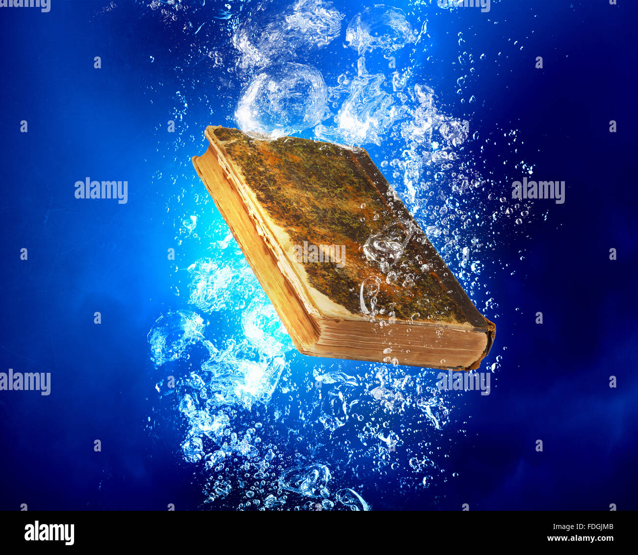 Old book sink in clear blue water Stock Photo - Alamy