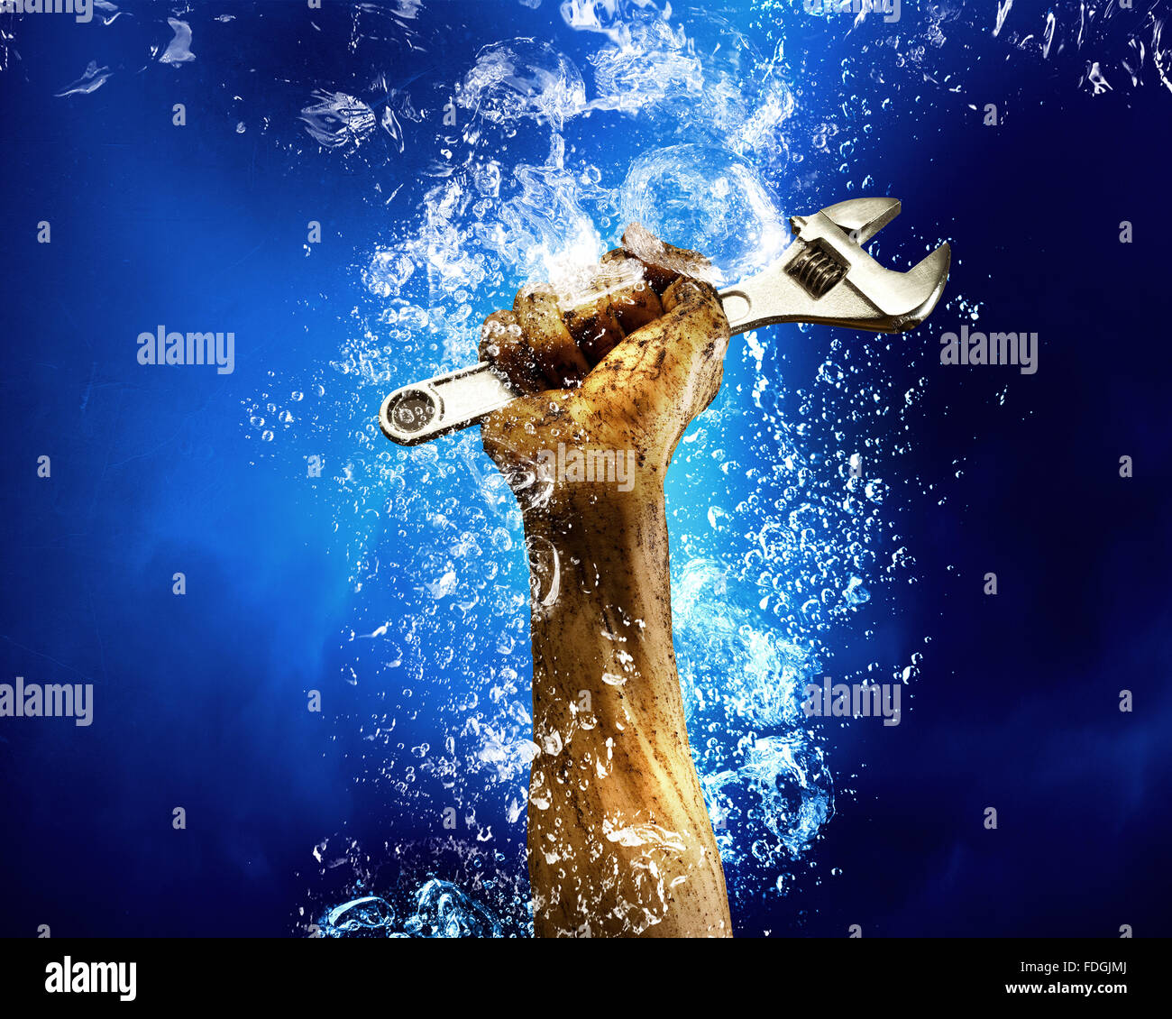 Hand with wrench in clear blue water Stock Photo - Alamy