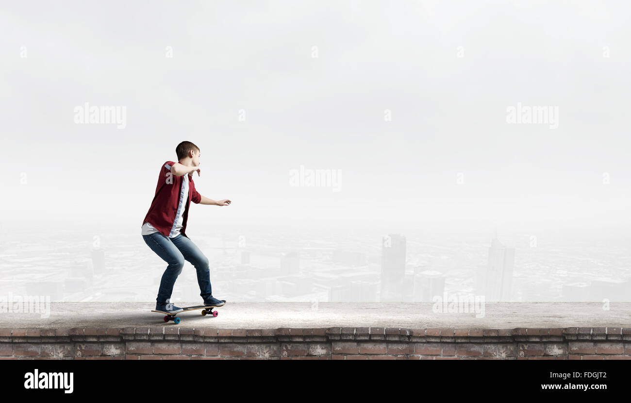 Handsome teenager cool acive boy riding skateboard Stock Photo - Alamy
