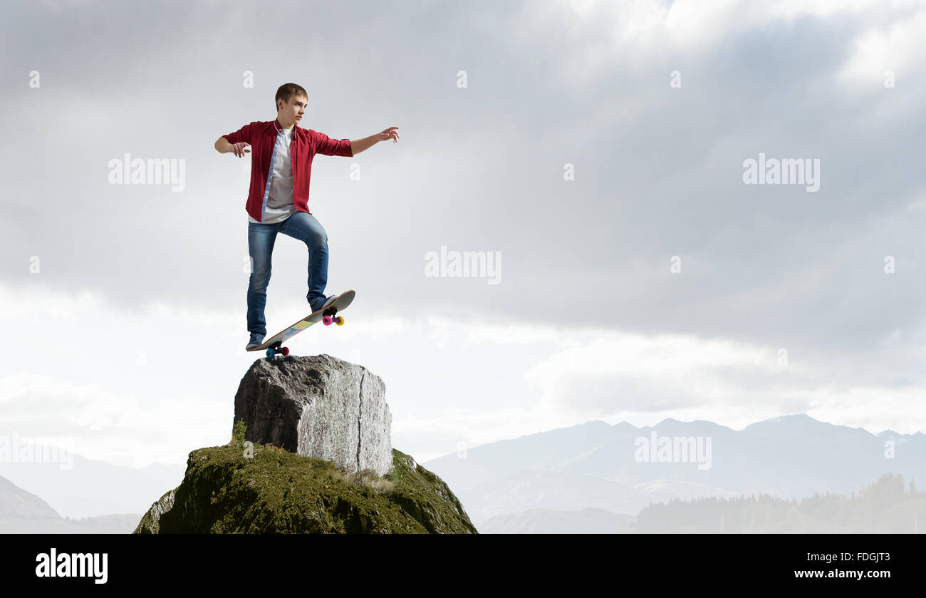 Handsome teenager cool acive boy riding skateboard Stock Photo - Alamy