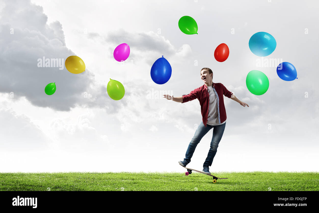 Handsome teenager cool acive boy riding skateboard Stock Photo - Alamy