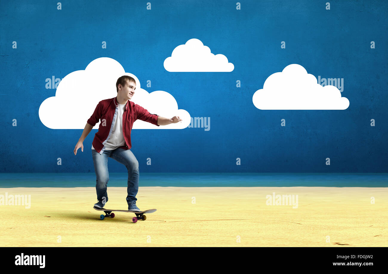 Handsome teenager cool acive boy riding skateboard Stock Photo - Alamy