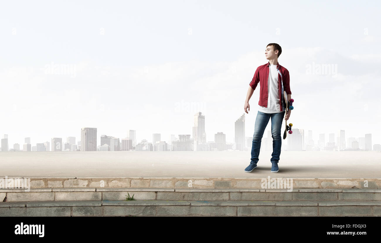 Handsome teenager cool acive boy riding skateboard Stock Photo - Alamy