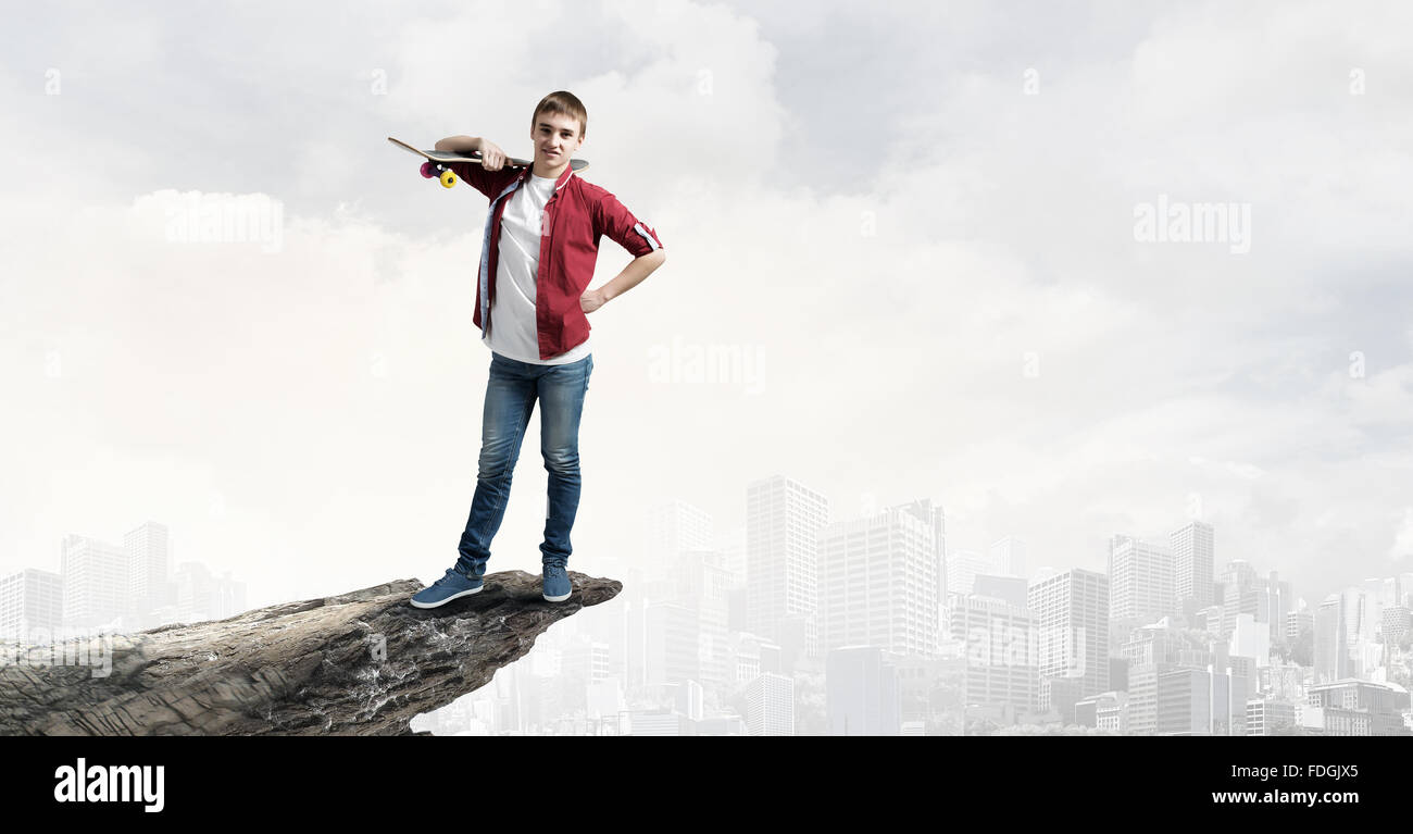 Handsome teenager cool acive boy riding skateboard Stock Photo - Alamy