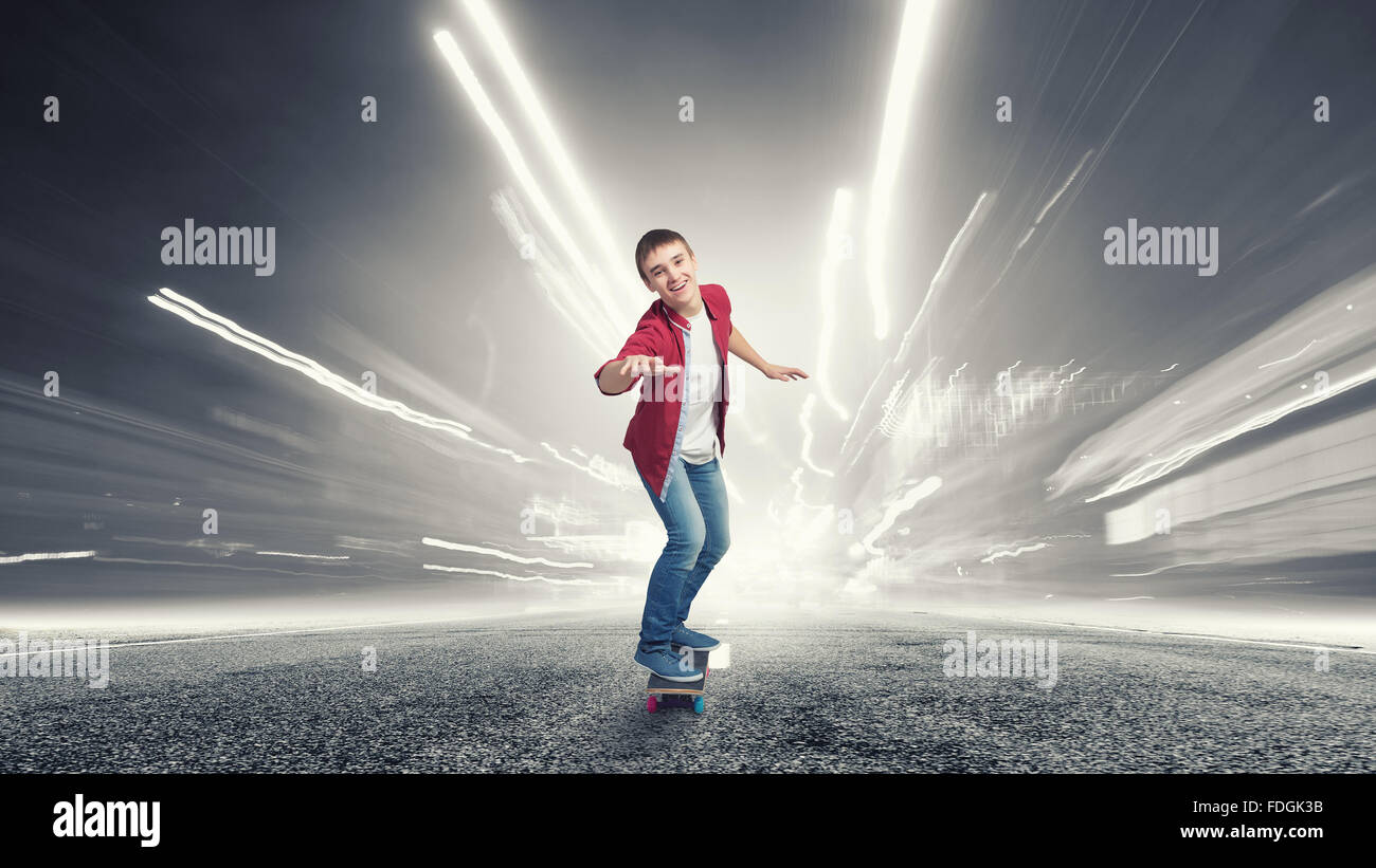 Handsome teenager cool acive boy riding skateboard Stock Photo - Alamy