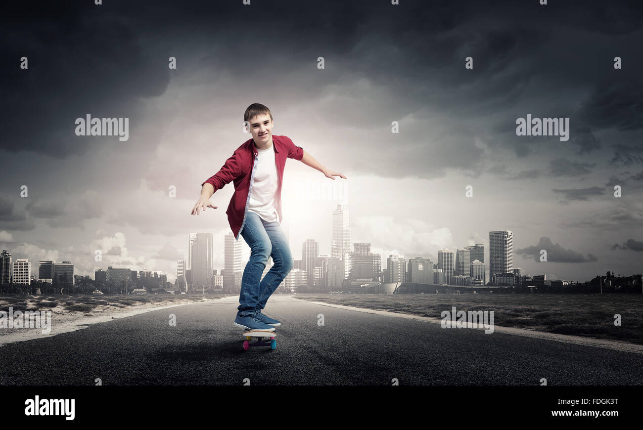 Handsome teenager cool acive boy riding skateboard Stock Photo - Alamy
