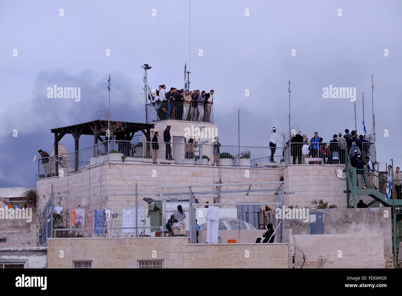 Orthodox Jews gazing from a rooftop of a building which Jewish settlers ...