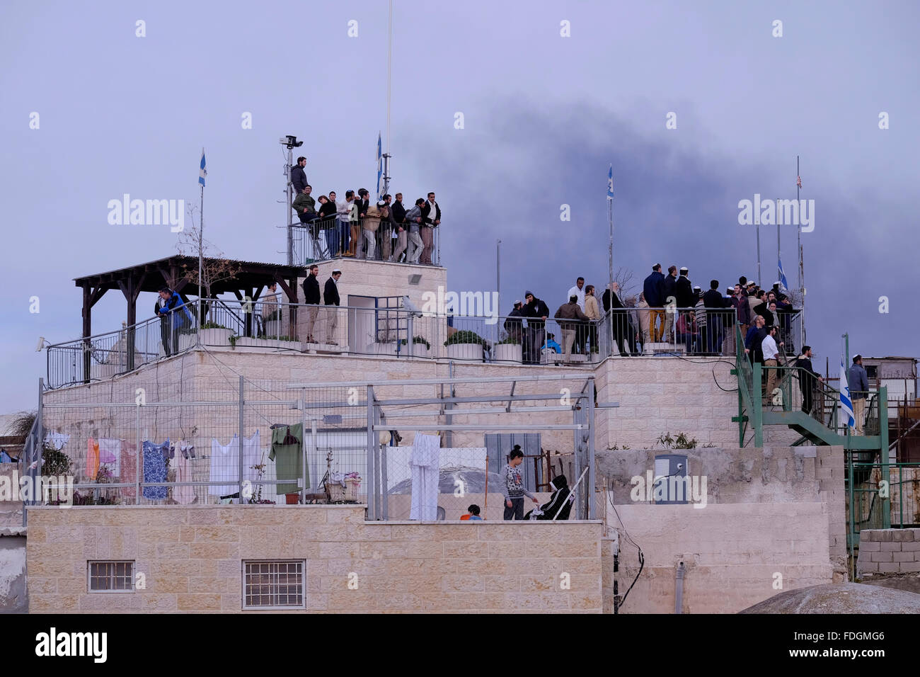Orthodox Jews gazing from a rooftop of a building which Jewish settlers ...