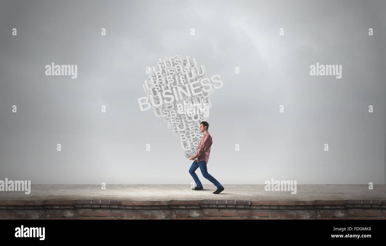 Young man carrying in hands heavy big successful idea concept Stock ...