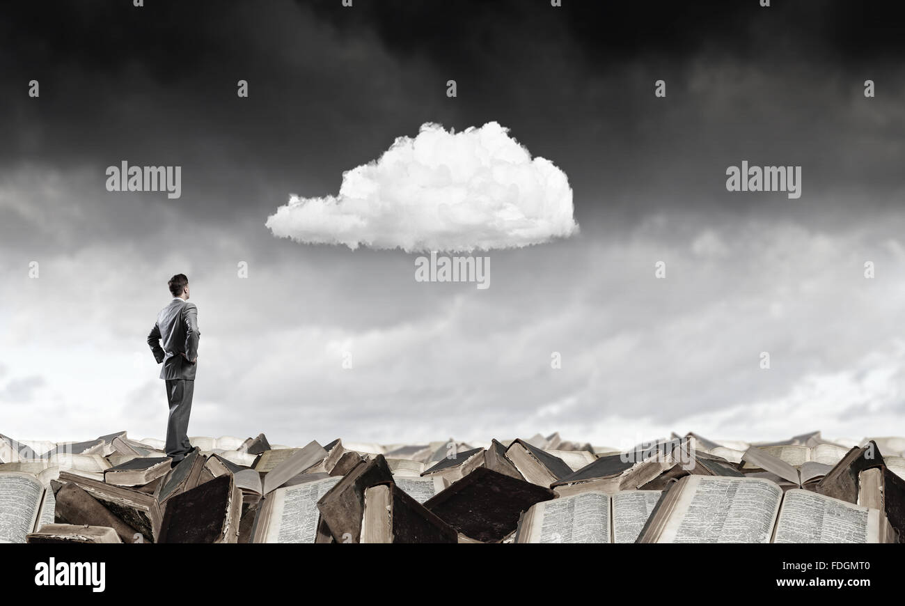 Man standing top on pile books hi-res stock photography and images - Alamy
