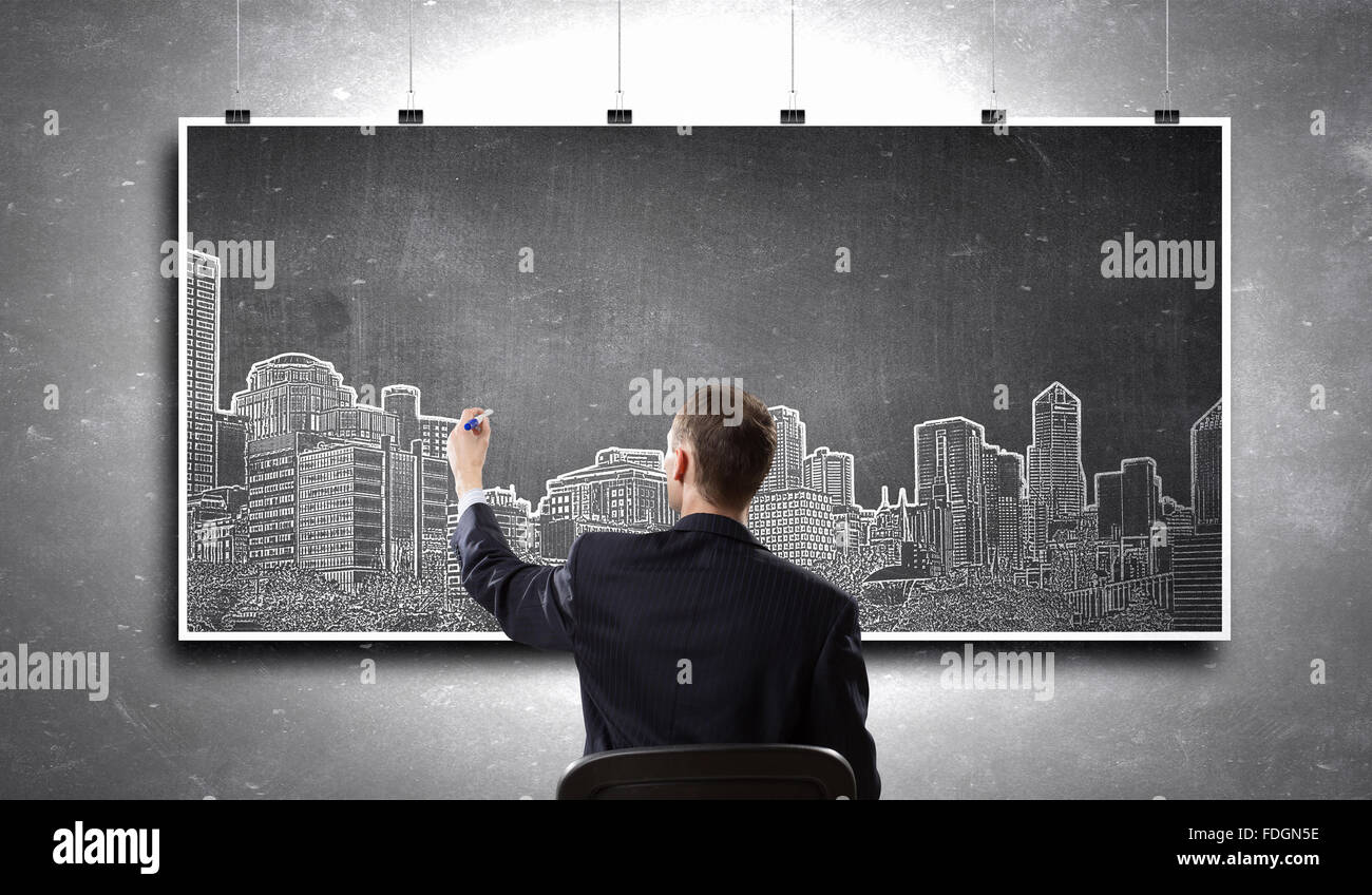 Rear view of businessman drawing construction project on banner Stock ...