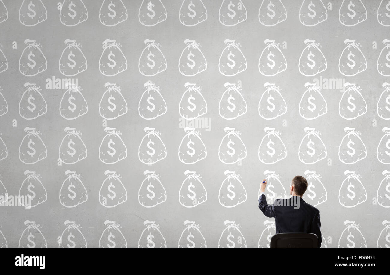 Rear view of businessman drawing with marker money earning concept ...