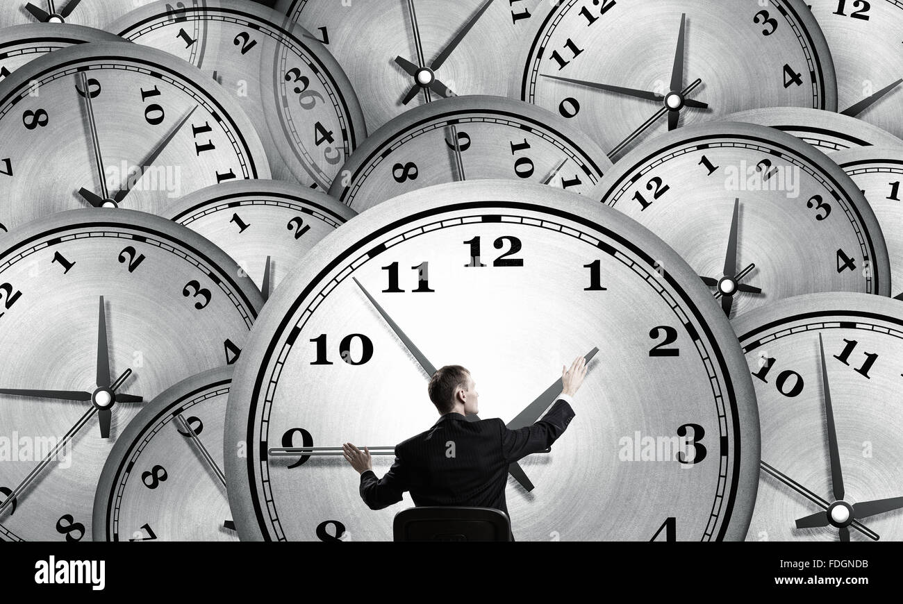 Rear view of businessman sitting in chair slowing time Stock Photo - Alamy