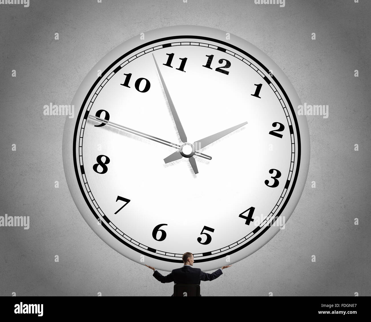 Rear view of businessman sitting in chair slowing time Stock Photo - Alamy