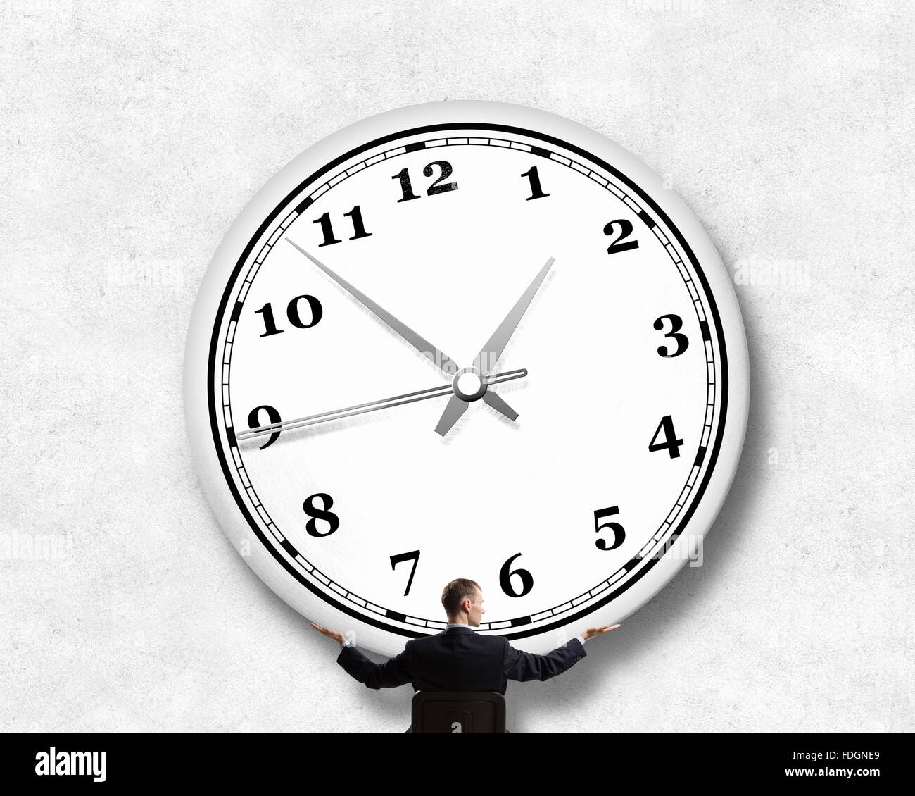 Rear view of businessman sitting in chair slowing time Stock Photo - Alamy