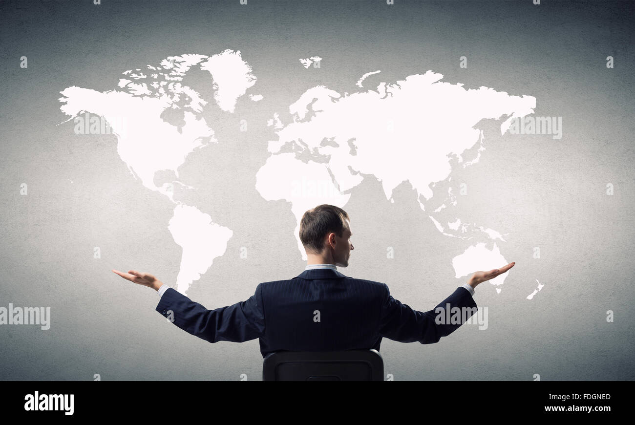 Businessman sitting in chair and cover world map with hands Stock Photo ...