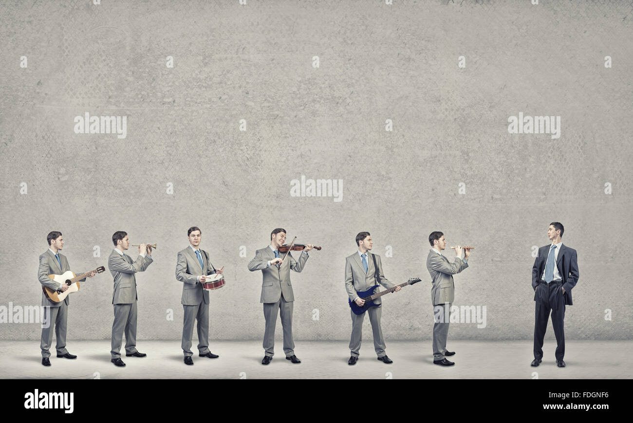 Man orchestra in suit playing different music instruments Stock Photo ...