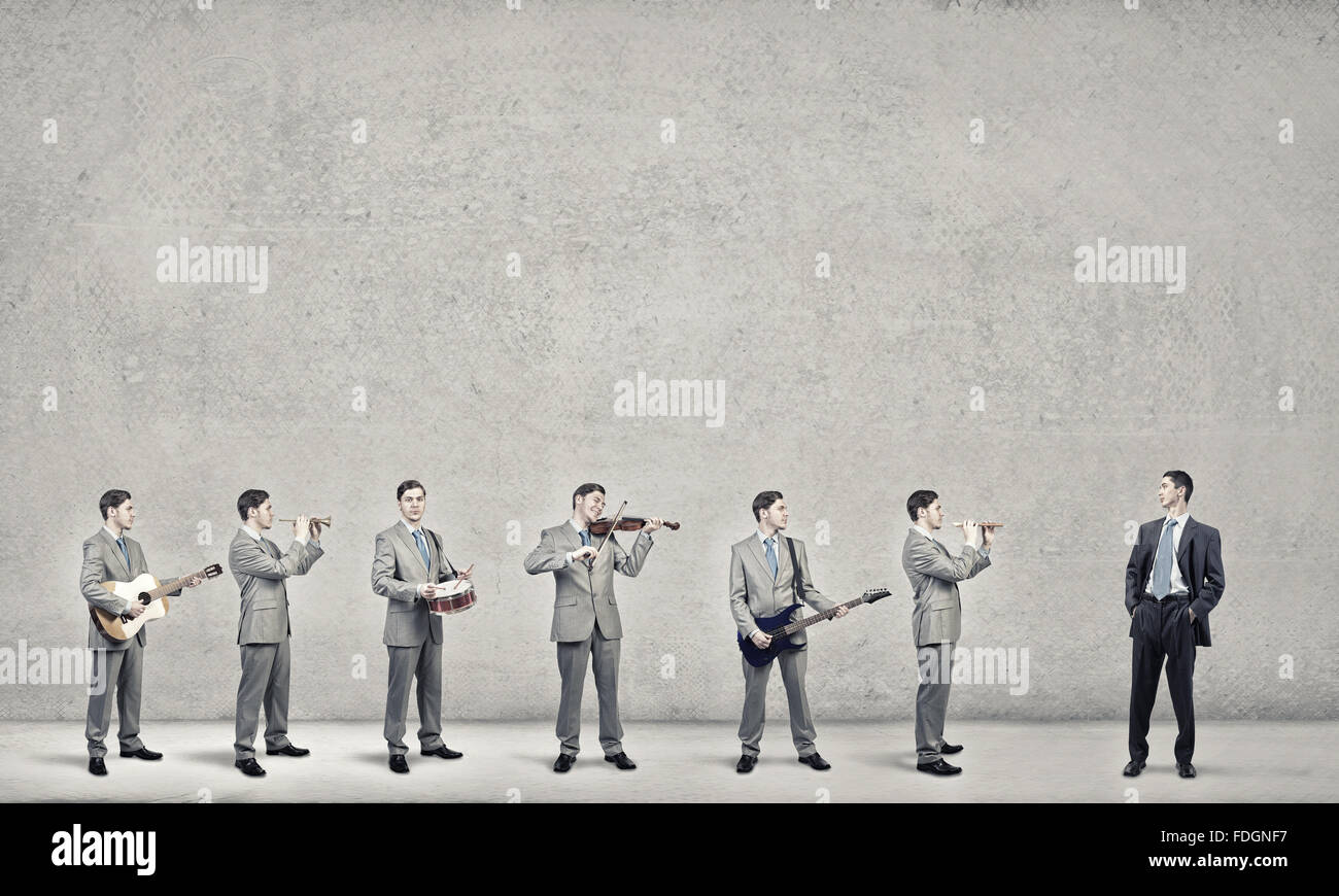 Man orchestra in suit playing different music instruments Stock Photo ...