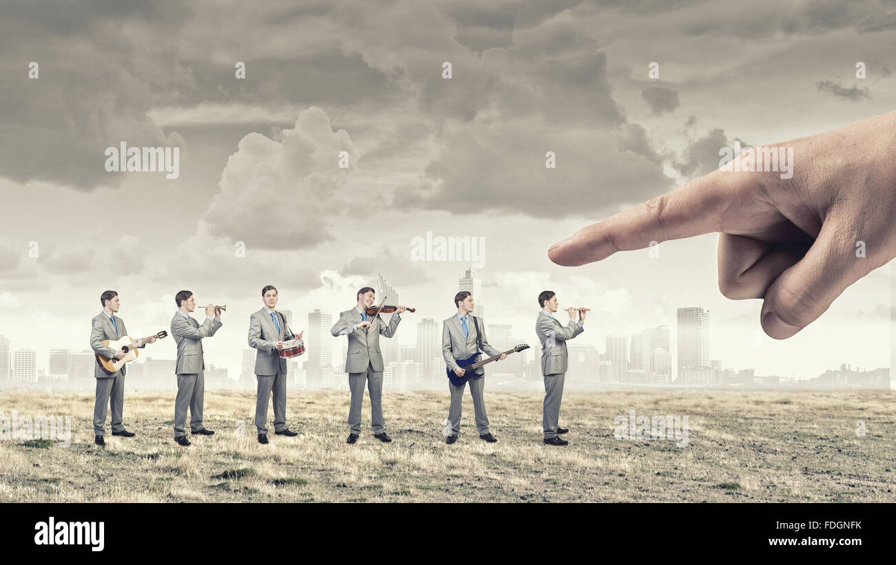 Man orchestra in suit playing different music instruments Stock Photo ...