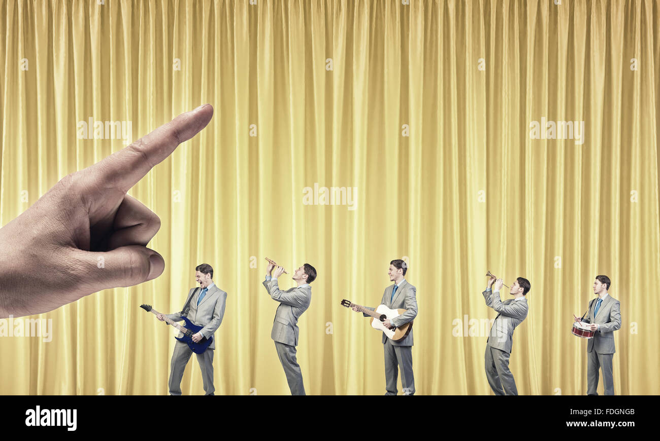 Man orchestra in suit playing different music instruments Stock Photo ...