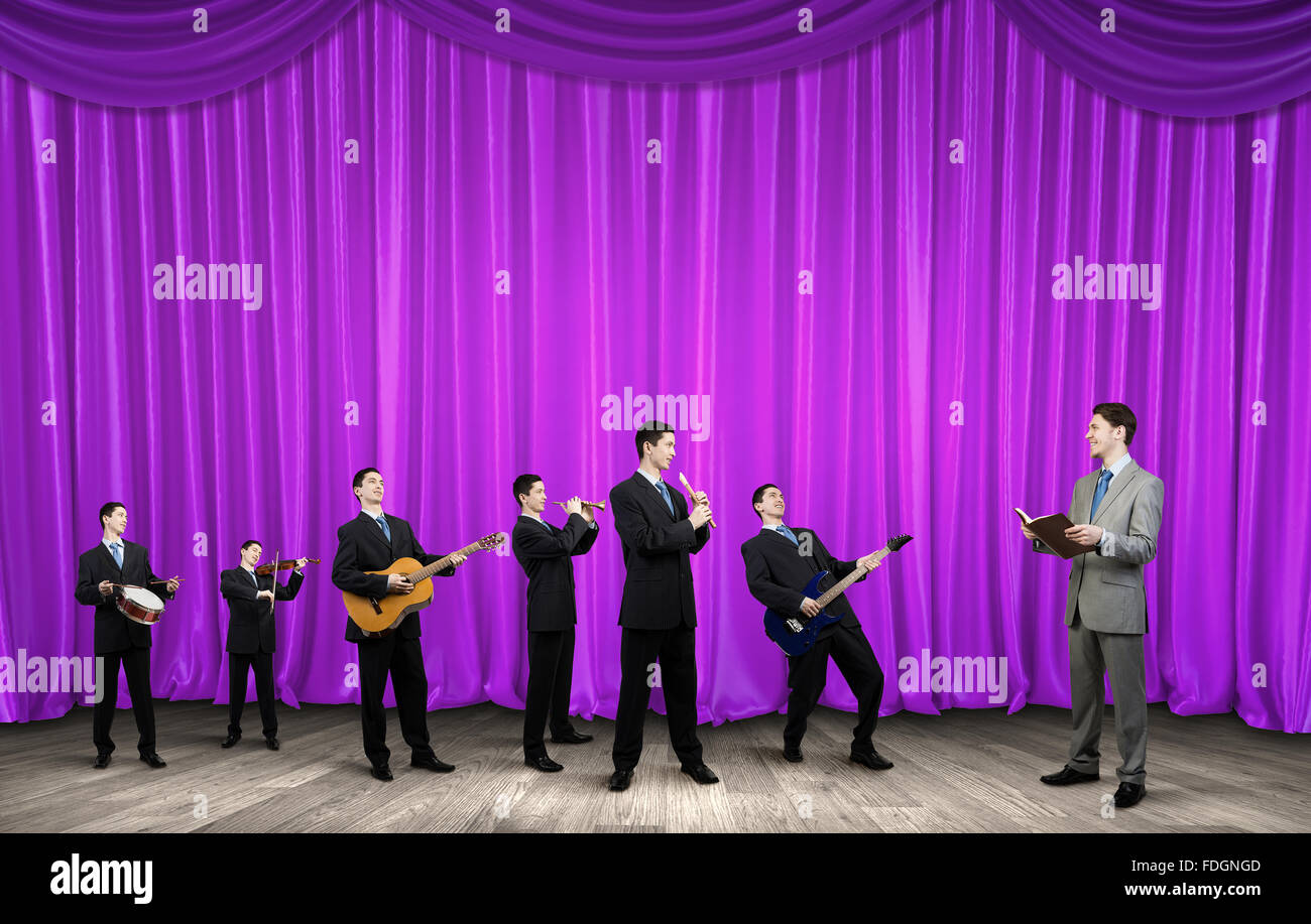 Man orchestra in suit playing different music instruments Stock Photo ...