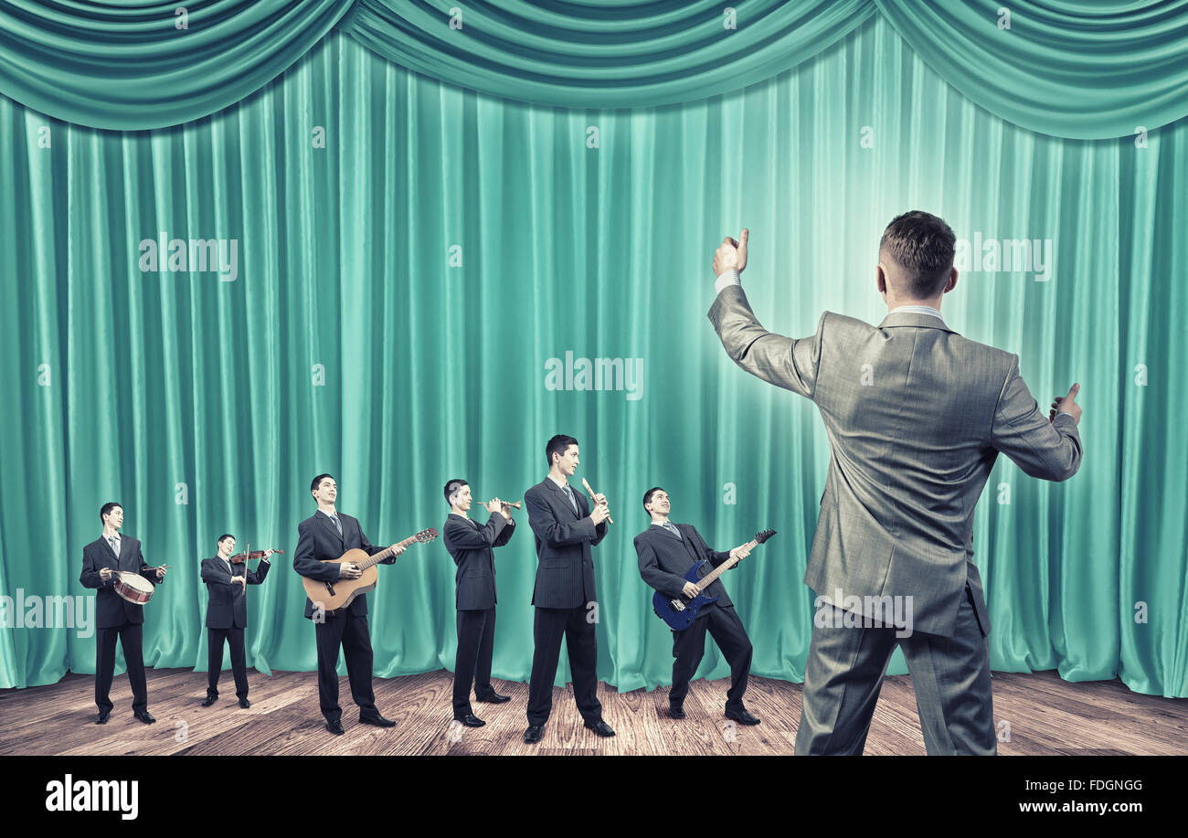 Man orchestra in suit playing different music instruments Stock Photo ...