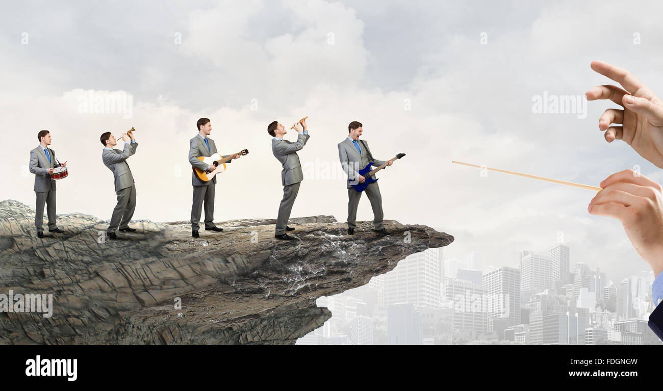 Man orchestra in suit playing different music instruments Stock Photo ...