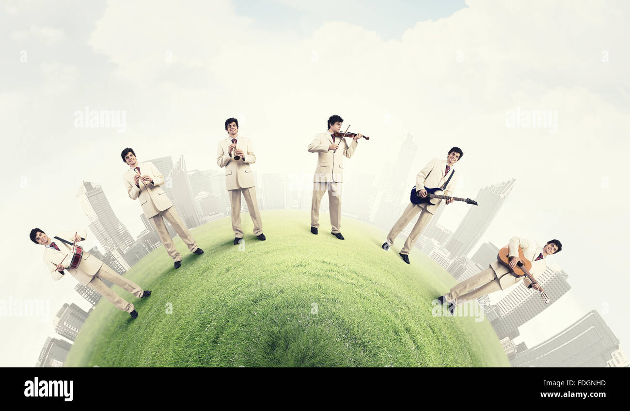 Man orchestra in suit playing different music instruments Stock Photo ...
