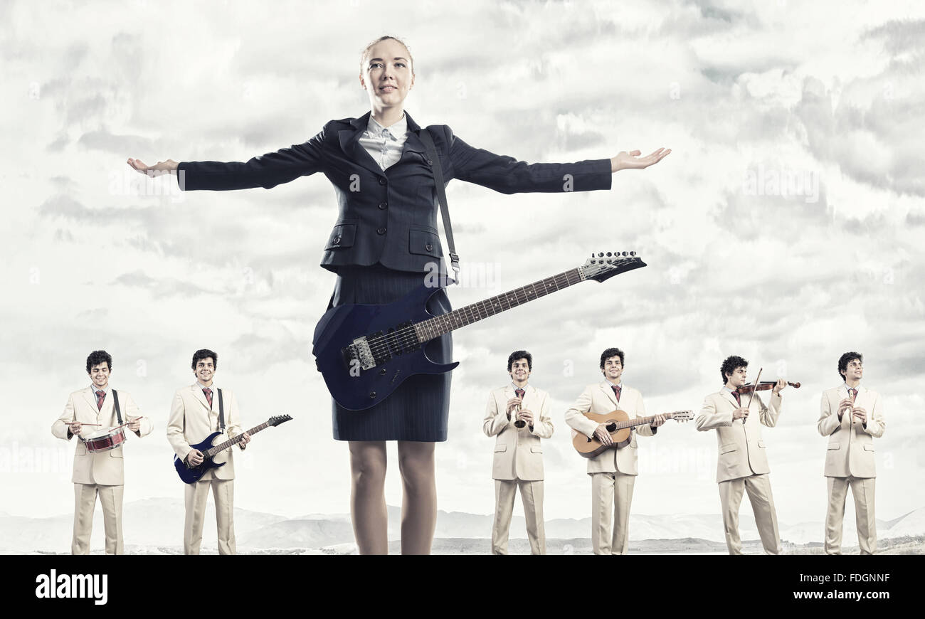 Man orchestra playing different music instruments and woman leader ...