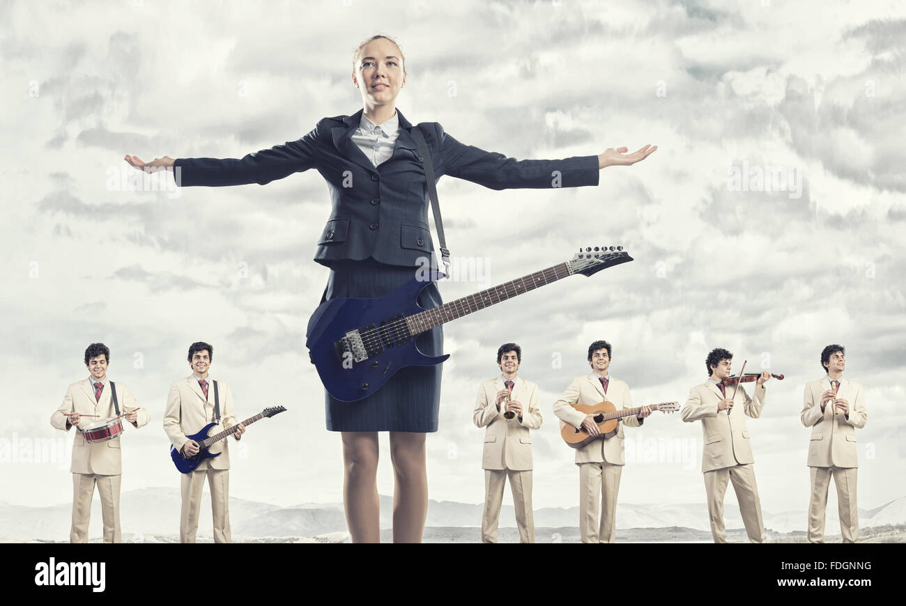 Man orchestra playing different music instruments and woman leader ...