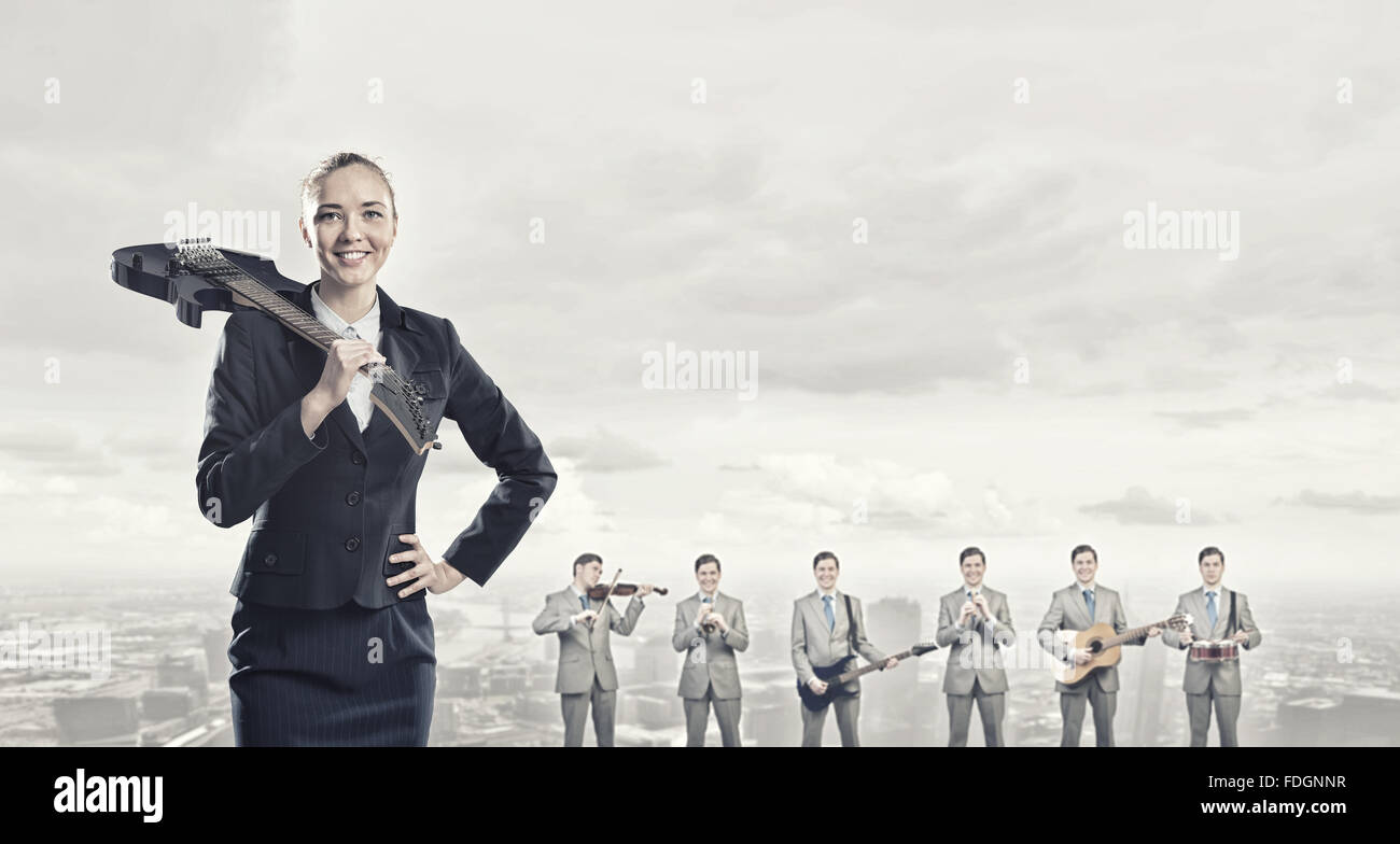 Man orchestra playing different music instruments and woman leader ...