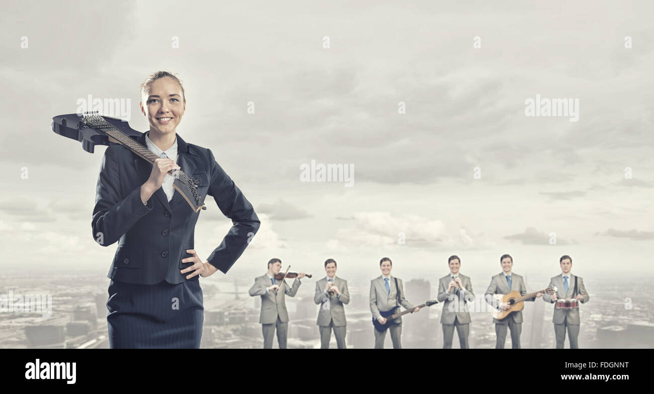 Man orchestra playing different music instruments and woman leader ...