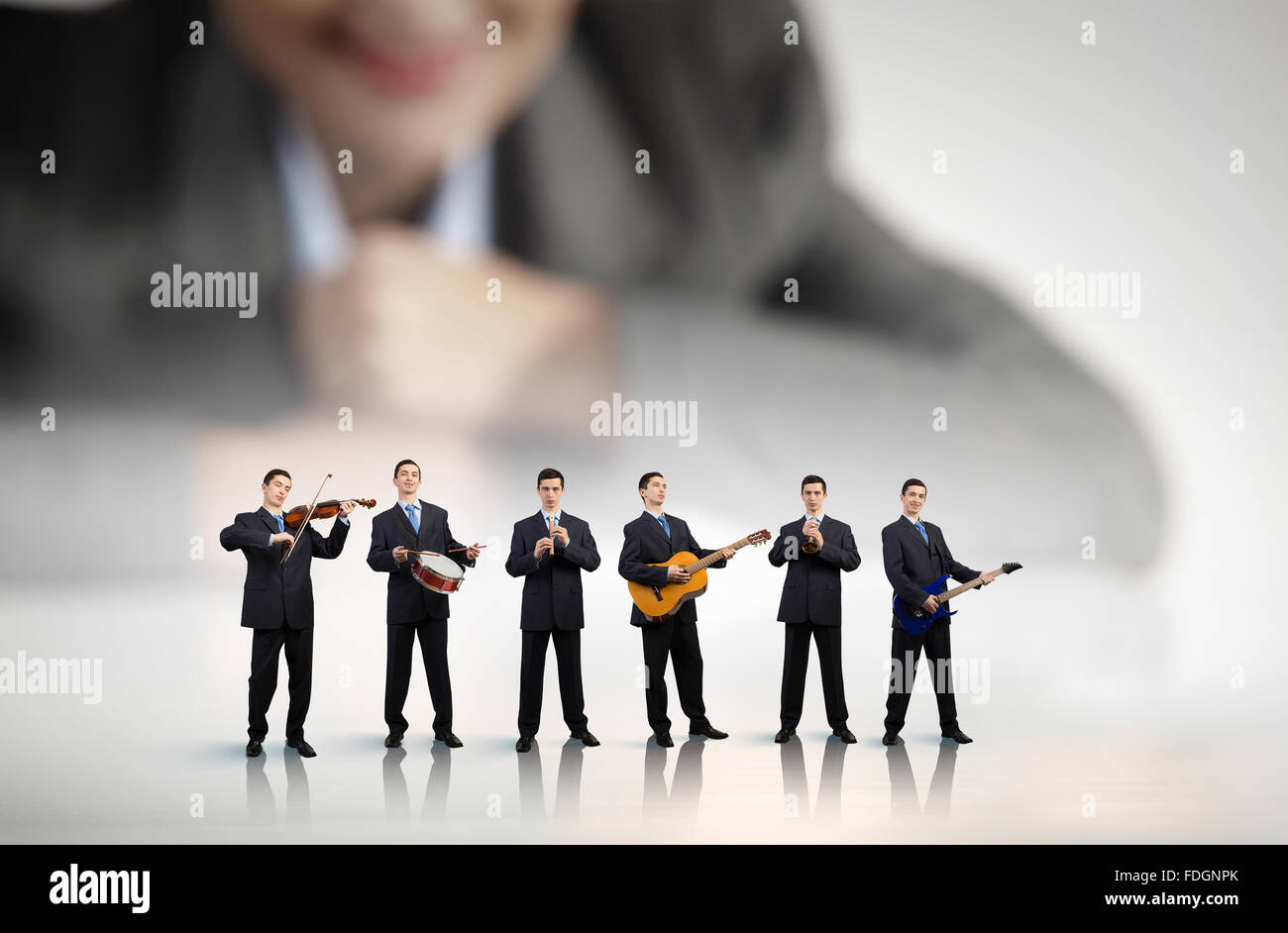 Man orchestra playing different music instruments and woman leader ...